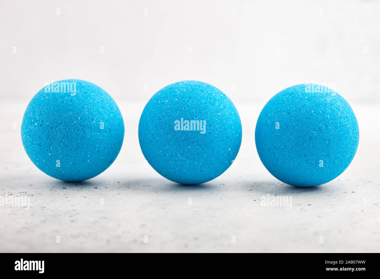 Blue bath bombs on white tabletop, close up view Stock Photo - Alamy