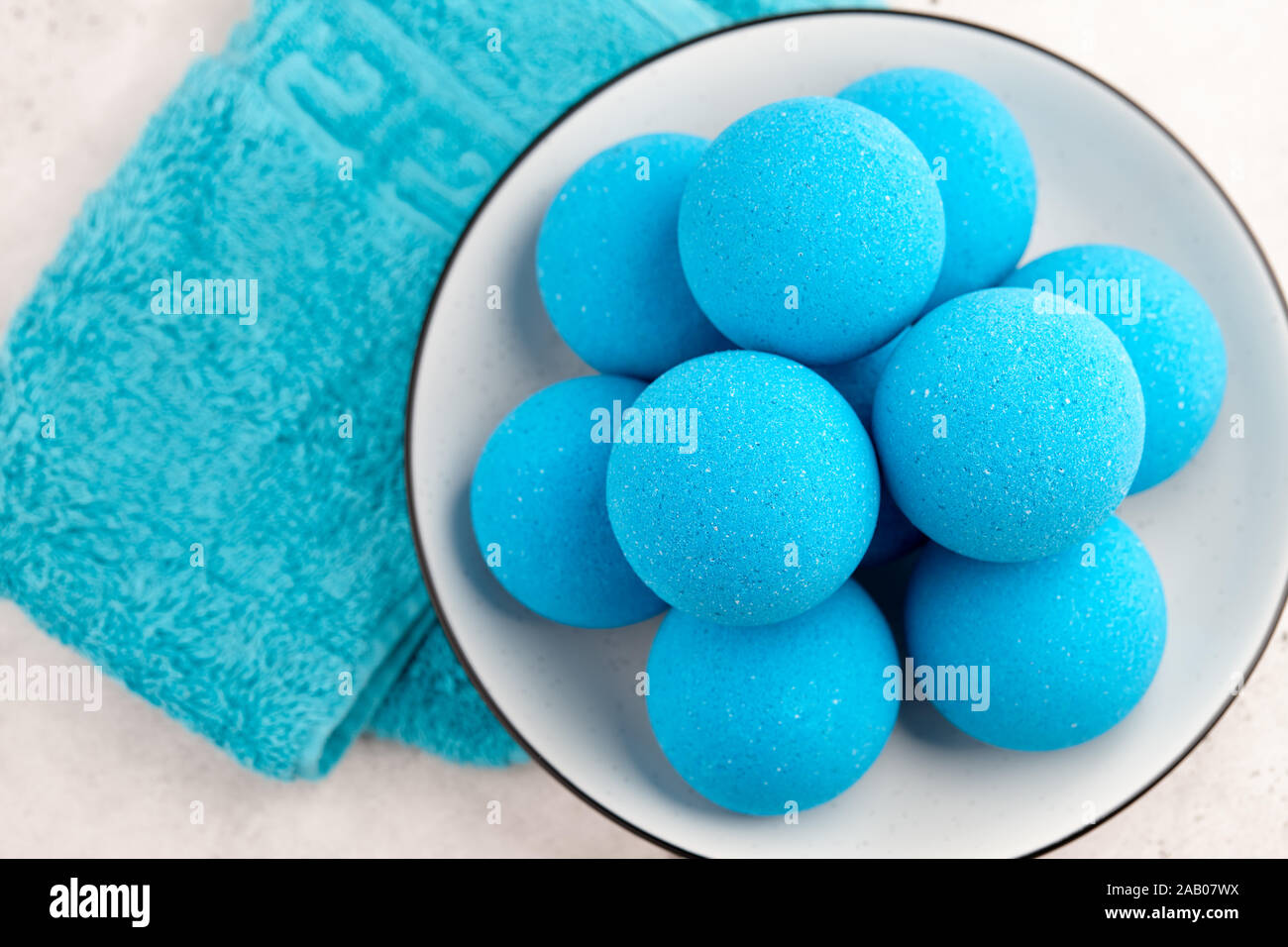 Blue bath bombs in plate on white tabletop, close up view Stock Photo ...