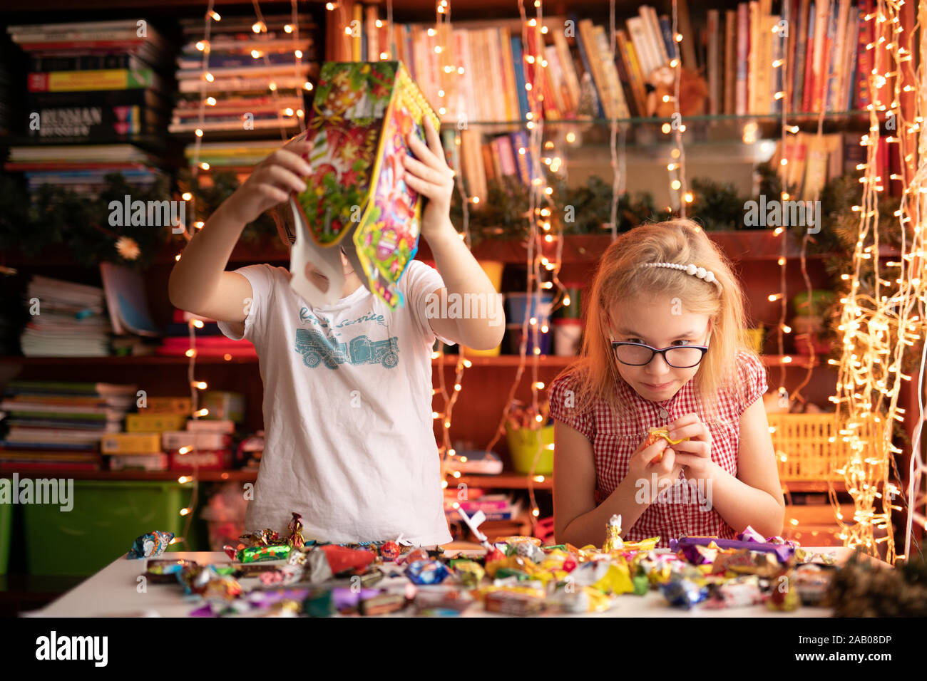 Children opening Christmas presents. Little girl and boy with present ...