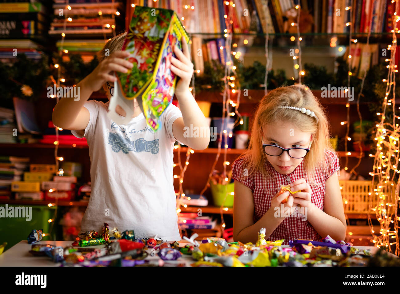 Children opening Christmas presents. Little girl and boy with present ...