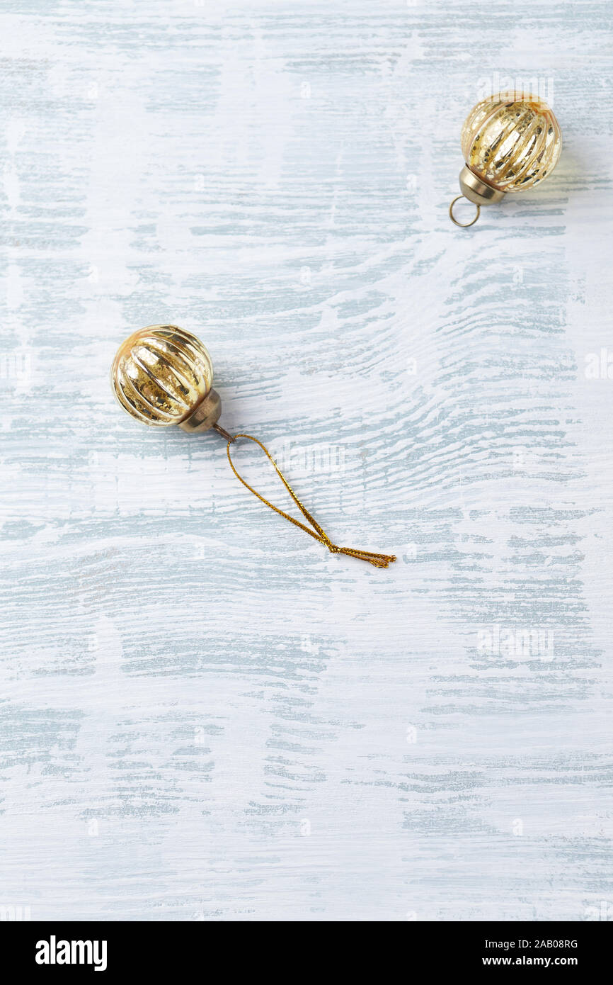 Christmas golden baubles on bright wooden background. Top view. Copy ...