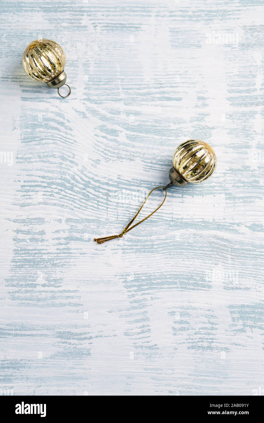Christmas golden baubles on bright wooden background. Top view. Copy ...
