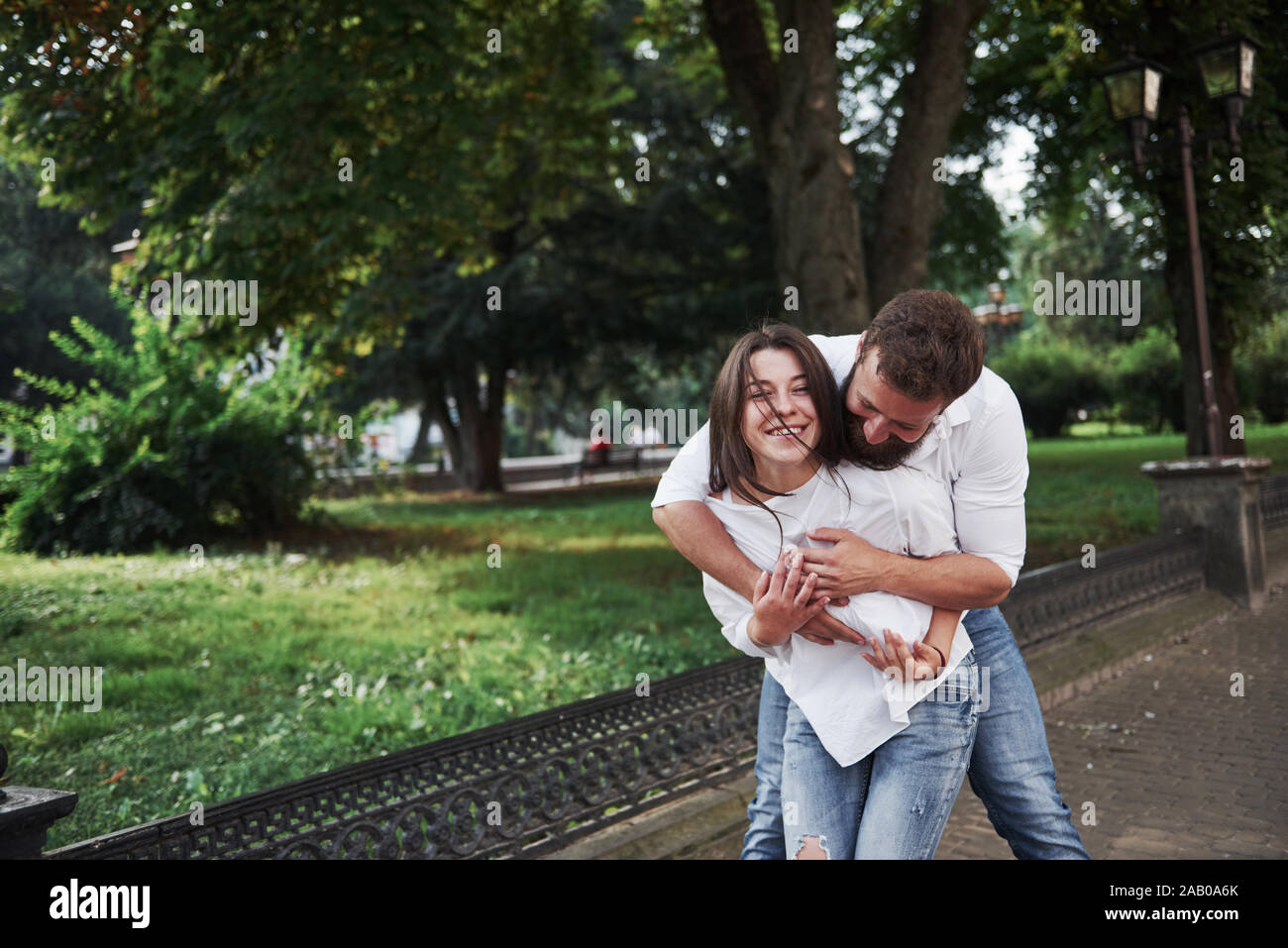 A young funny loving couple have fun on a sunny day Stock Photo - Alamy