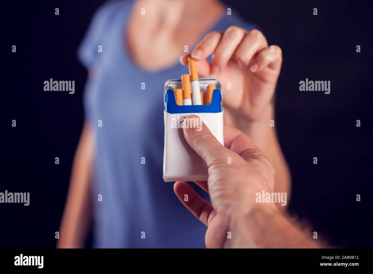 Woman takes cigarette on black background. Tobacco addiction concept ... Woman takes cigarette on black background. Tobacco addiction concept ...