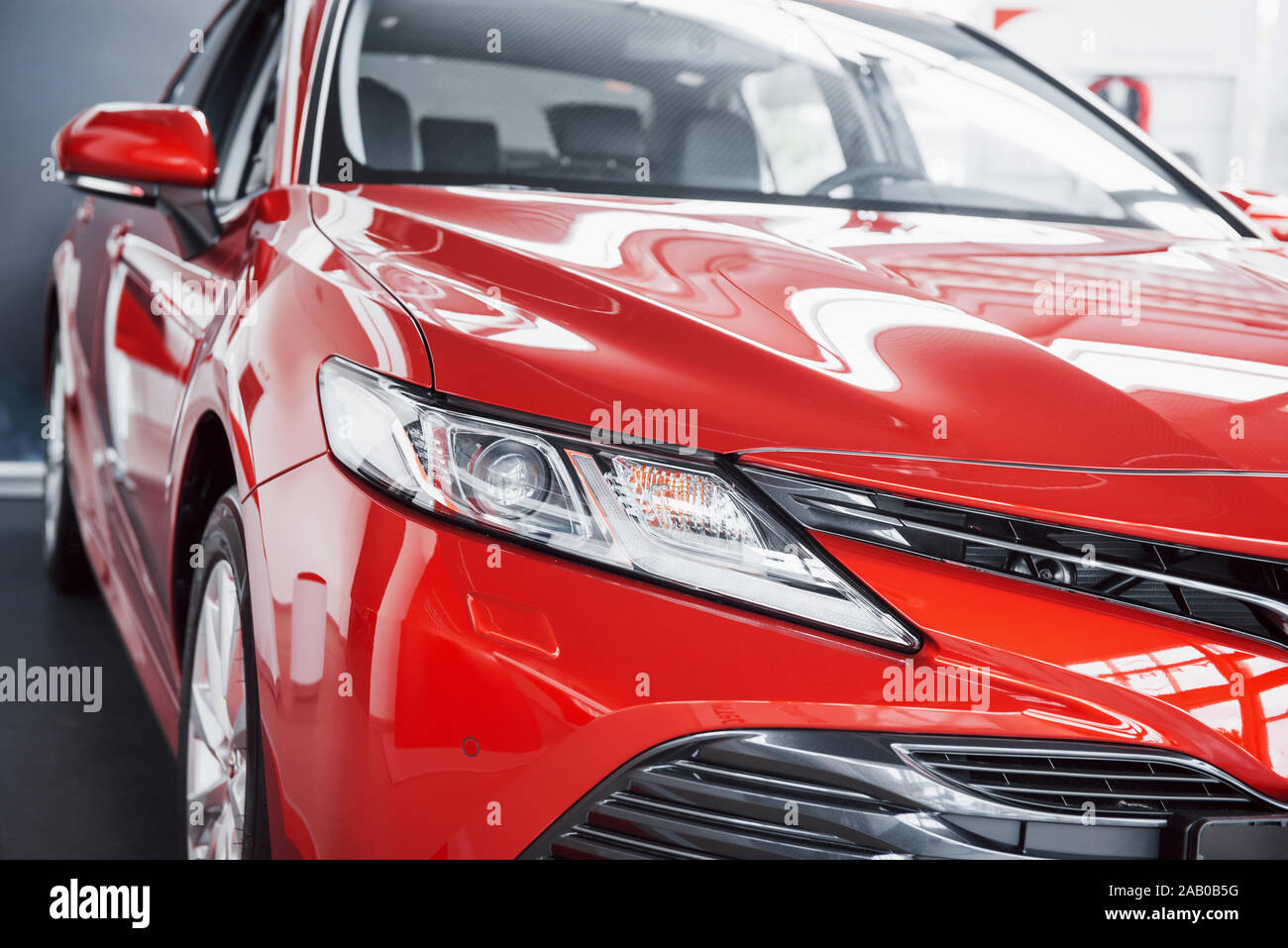 Headlights of the new red car, in the car dealership Stock Photo - Alamy