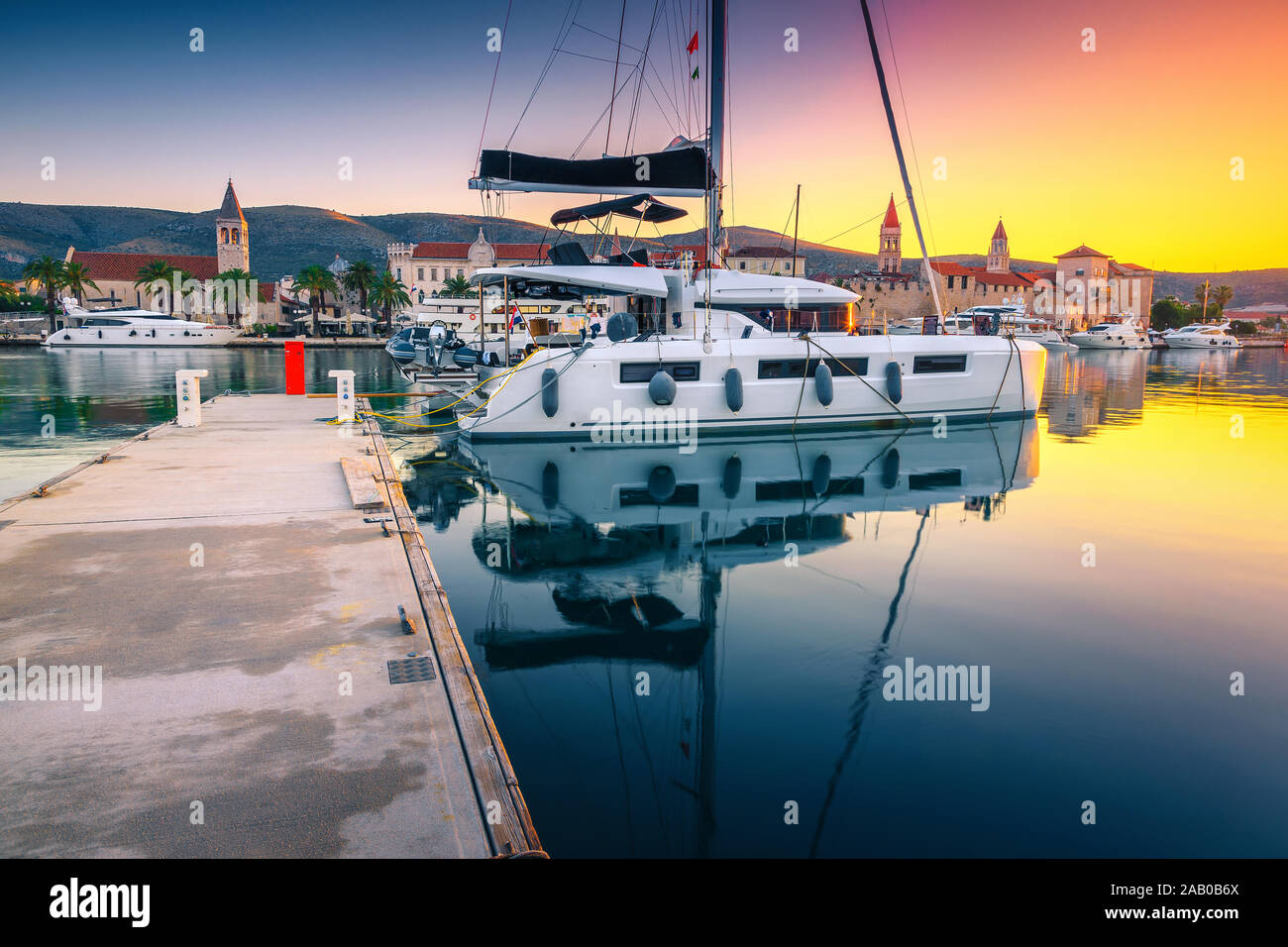 Stunning colorful dawn with magical sunrise. Moored sailing boats and ...