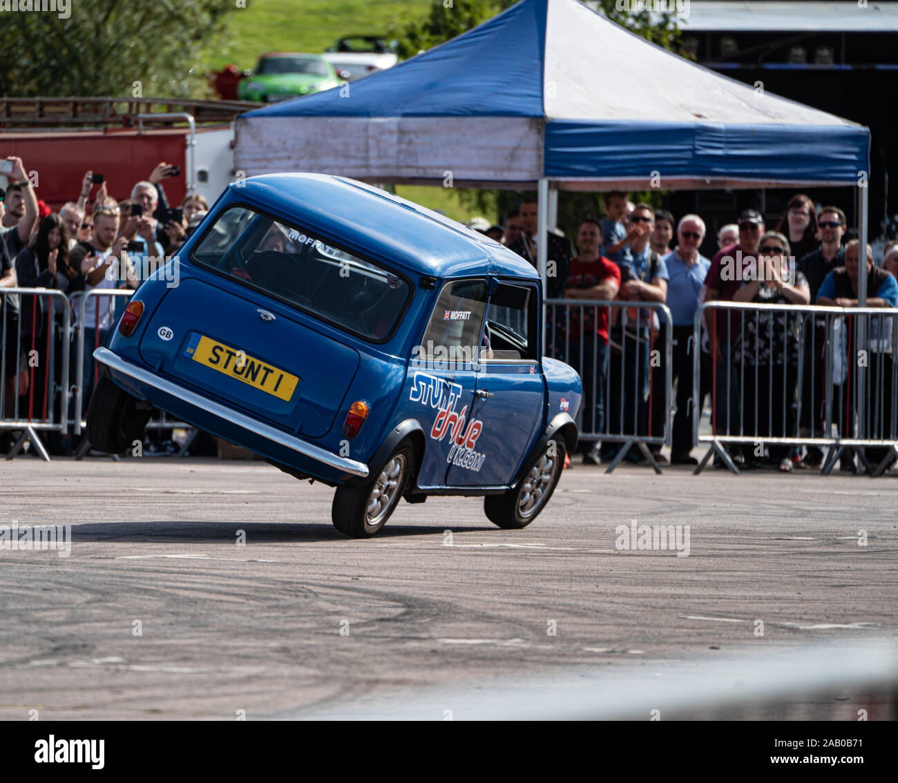 Stunt car Austin Mini on two wheels Stock Photo - Alamy
