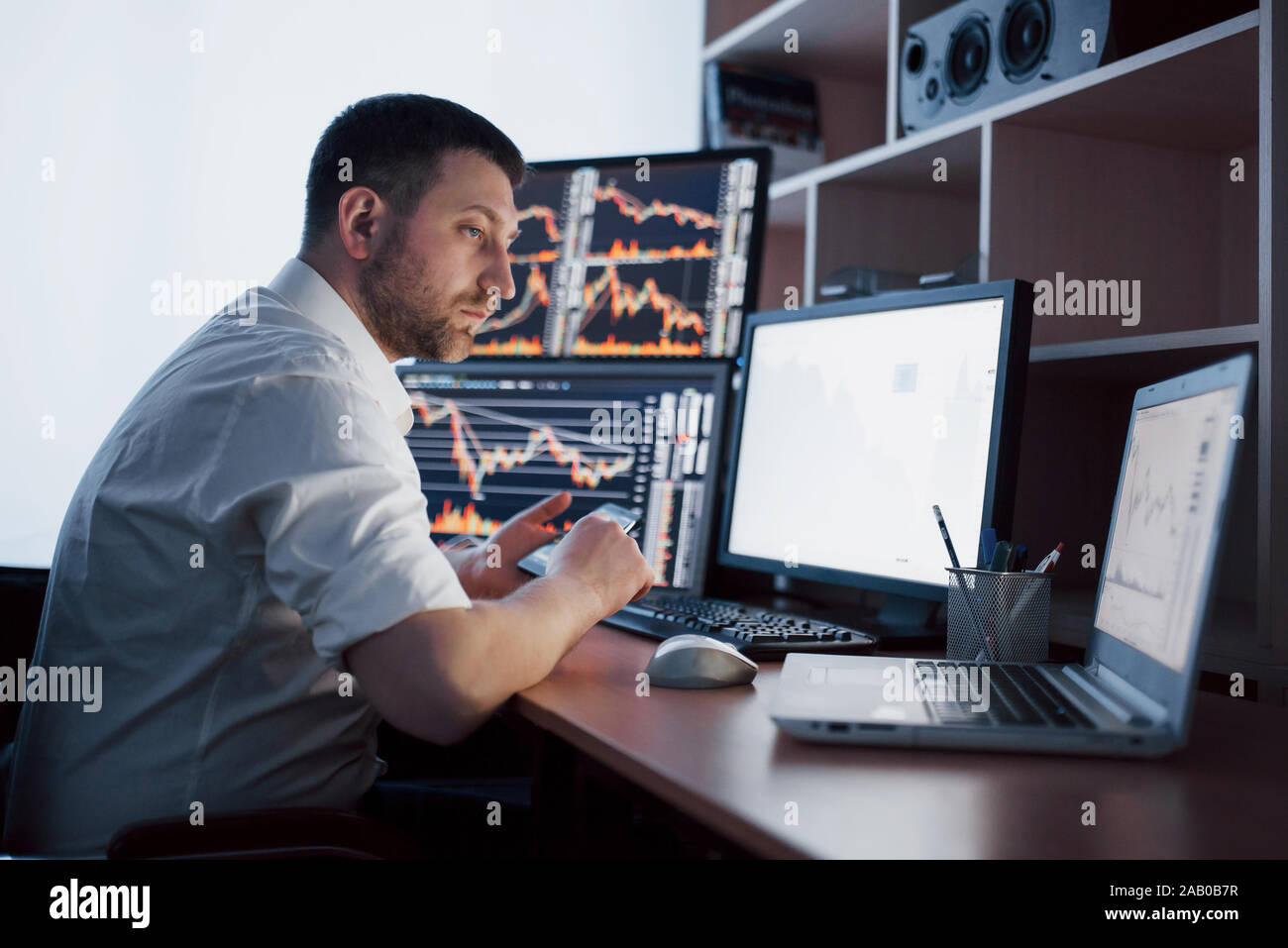 Busy working day. Close-up of young businessman looking at monitor ...