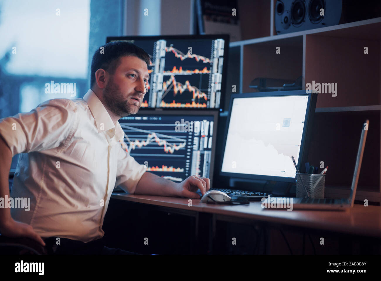 Busy working day. Close-up of young businessman looking at monitor ...