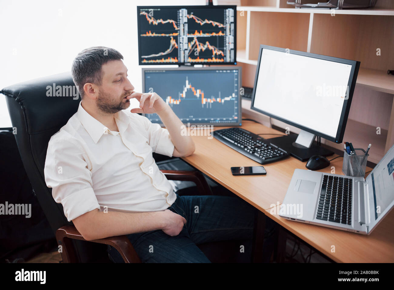 Busy working day. Close-up of young businessman looking at monitor ...