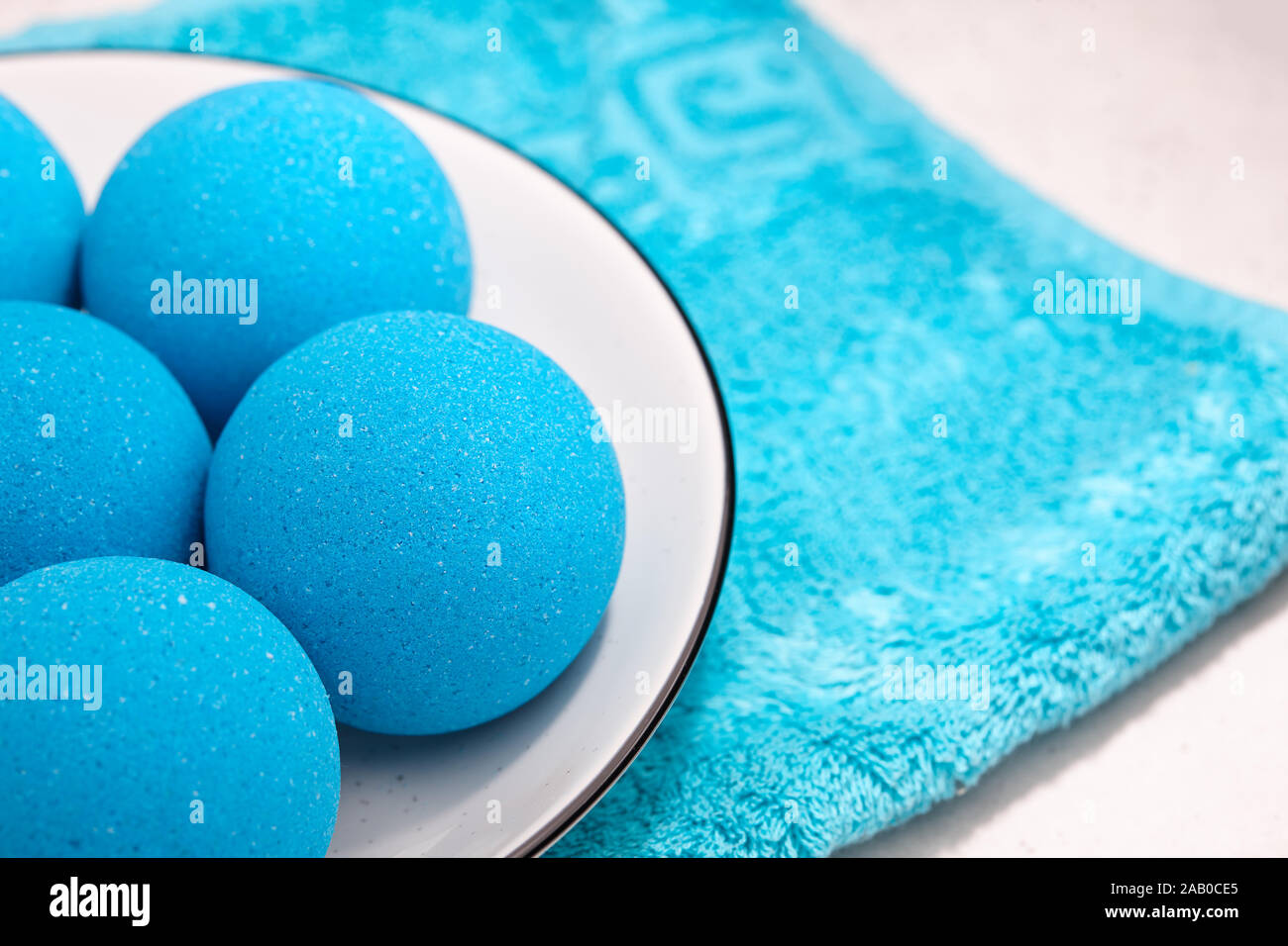 Blue bath bombs with towel on white tabletop, copy space Stock Photo ...