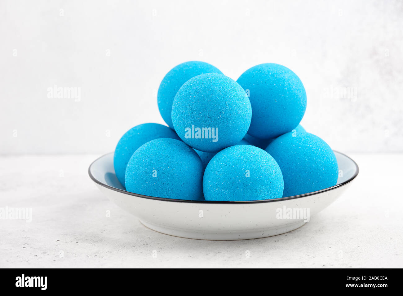 Blue bath bombs in plate on white tabletop, close up view Stock Photo ...