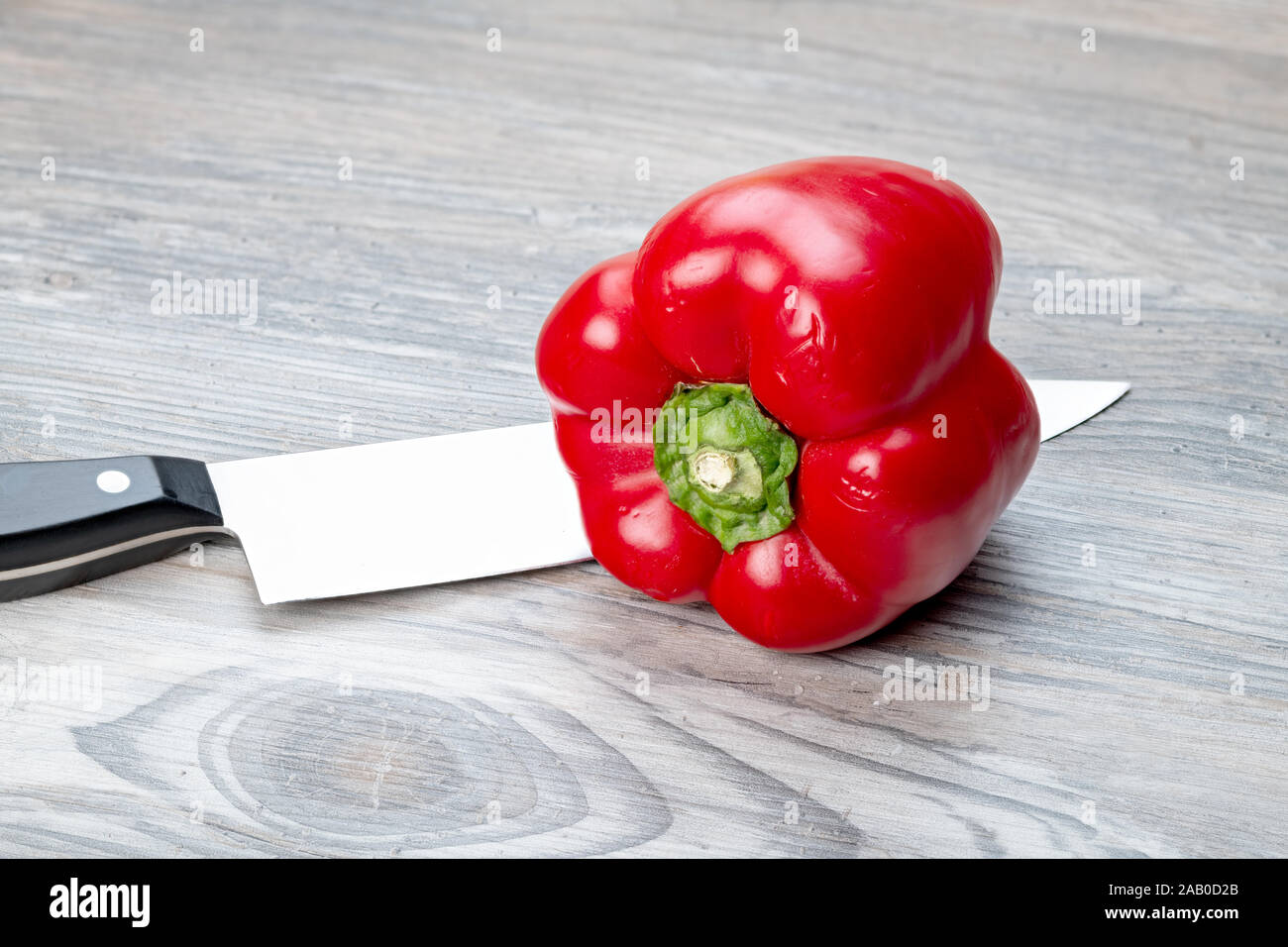 Knife and pepper on a wood tabletop Stock Photo - Alamy