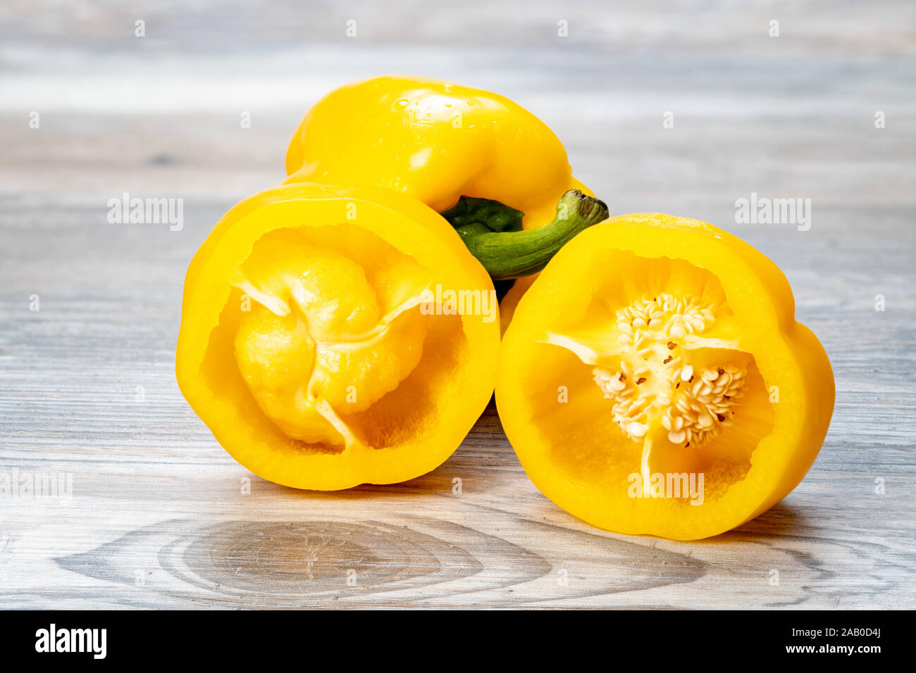Bell pepper yellow in color cut in half showing center Stock Photo - Alamy