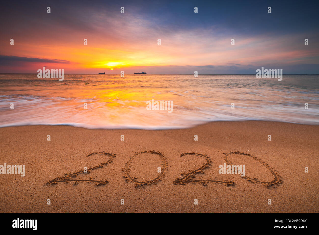 Happy New Year 2020 concept, lettering on the beach. Sea sunrise Stock ...