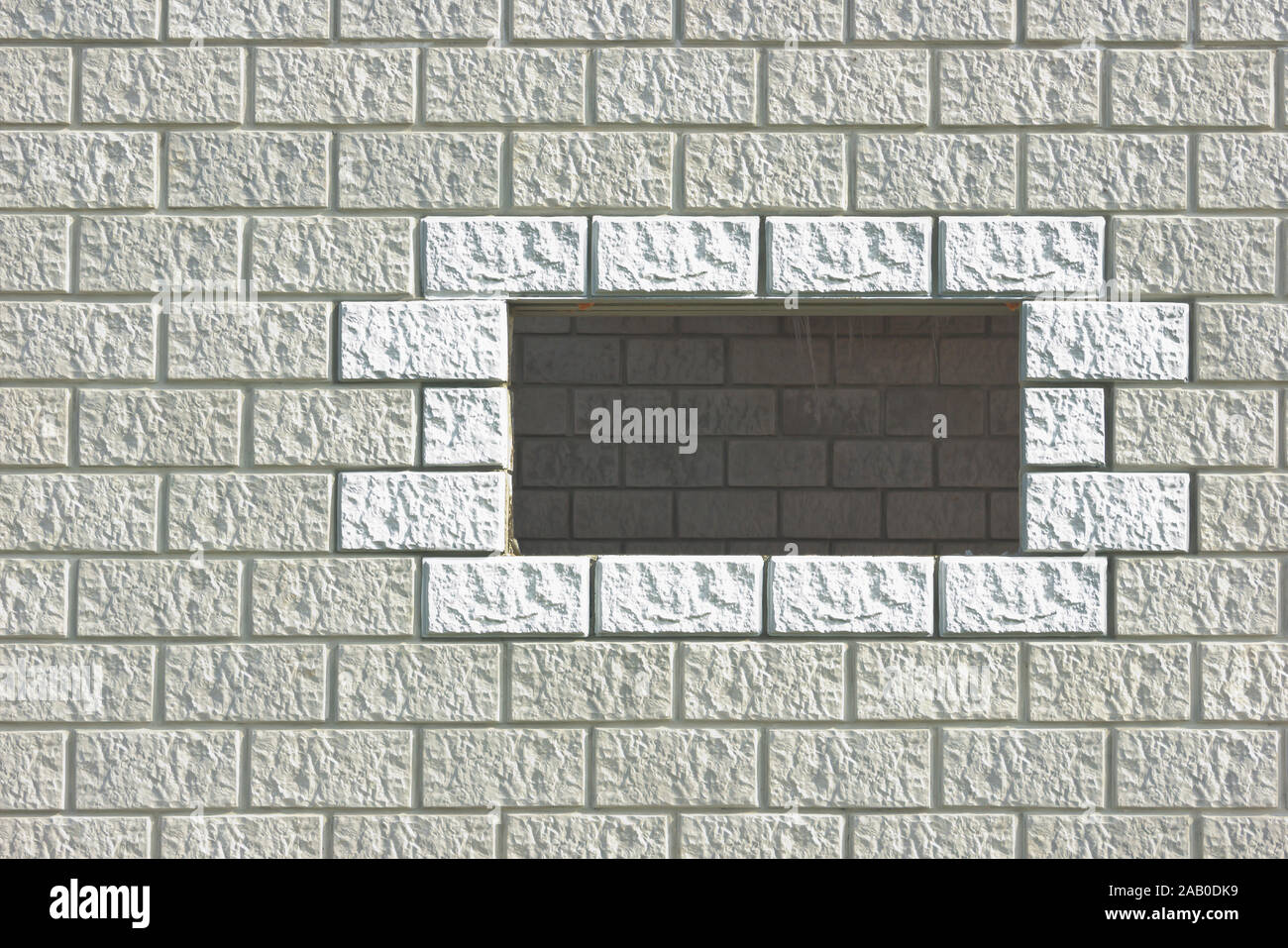 Finishing the building wall with decorative brick. Window aperture ...