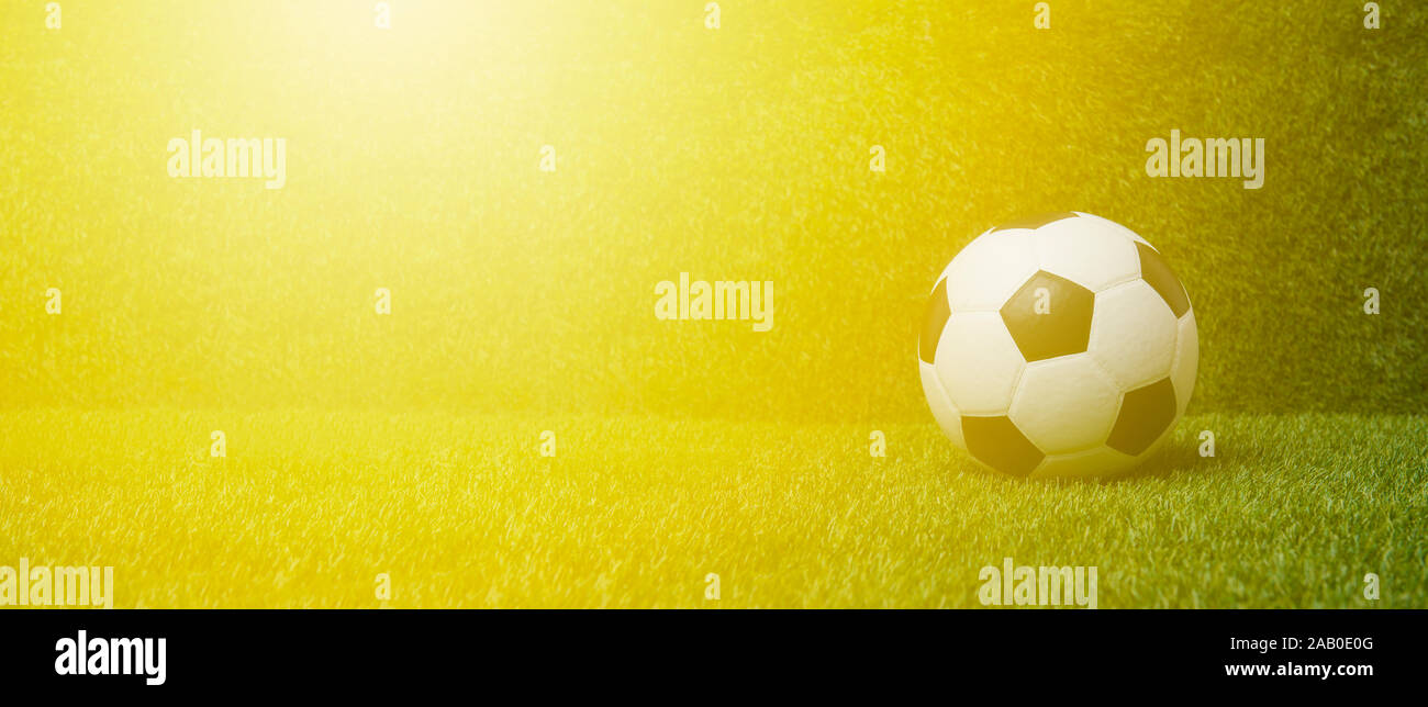 Black and white soccer ball on green soccer pitch. Yellow filter Stock ...