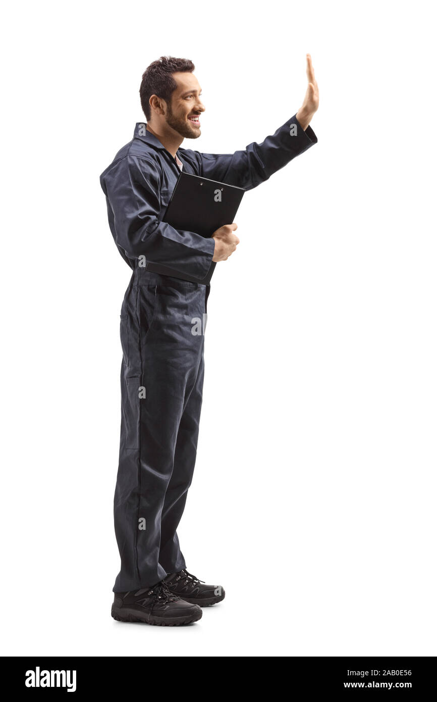 Full length profile shot of an auto mechanic gesturing with hand ...