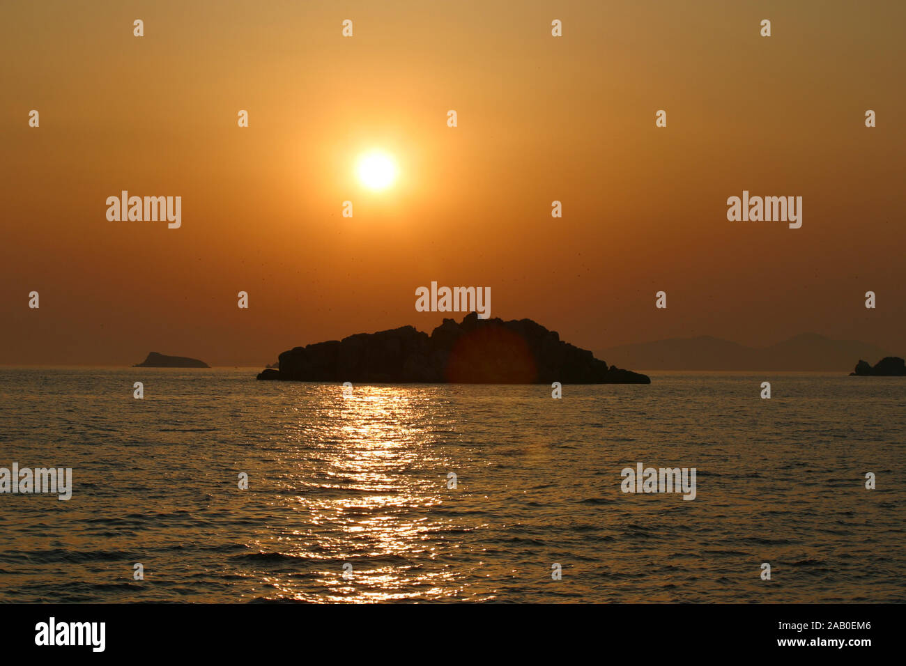 sunset in greece with ocean and greek islands Stock Photo - Alamy