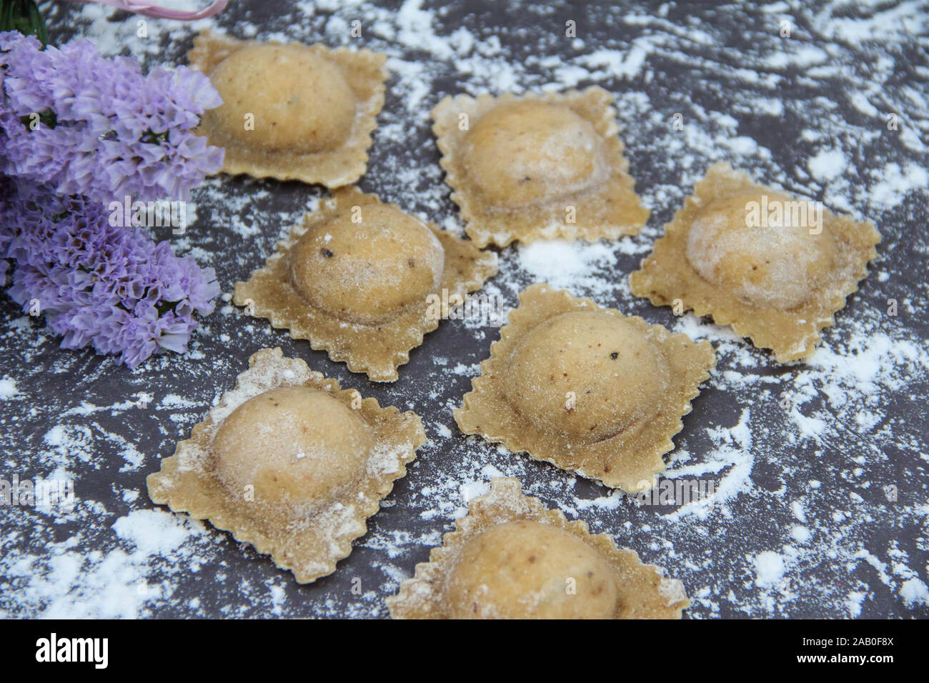 Raw ravioli on dark background. Italian food Stock Photo - Alamy
