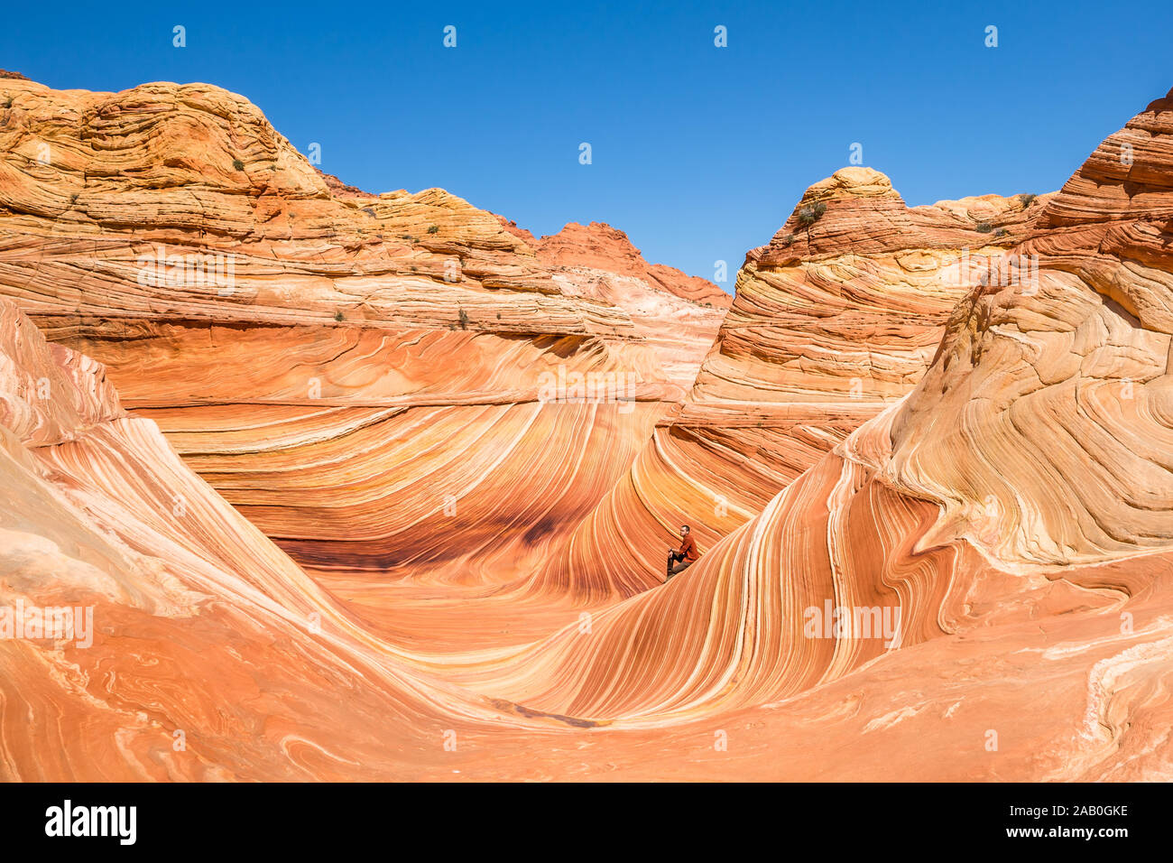 Hiker stopped to enjoy the view and think while inside the famous Wave ...
