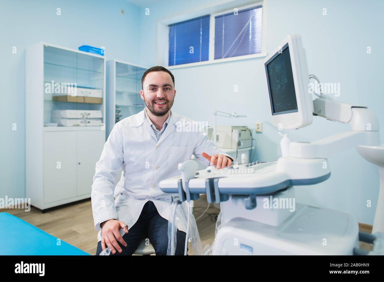 handsome doctor using an ultrasound machine Stock Photo - Alamy