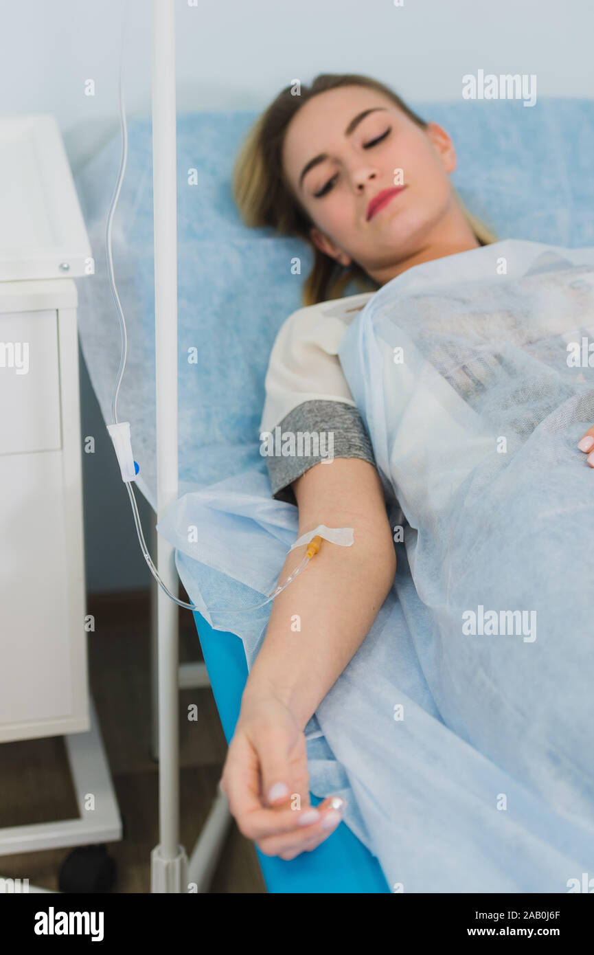 Patient hand with IV drop and patient tag Stock Photo - Alamy