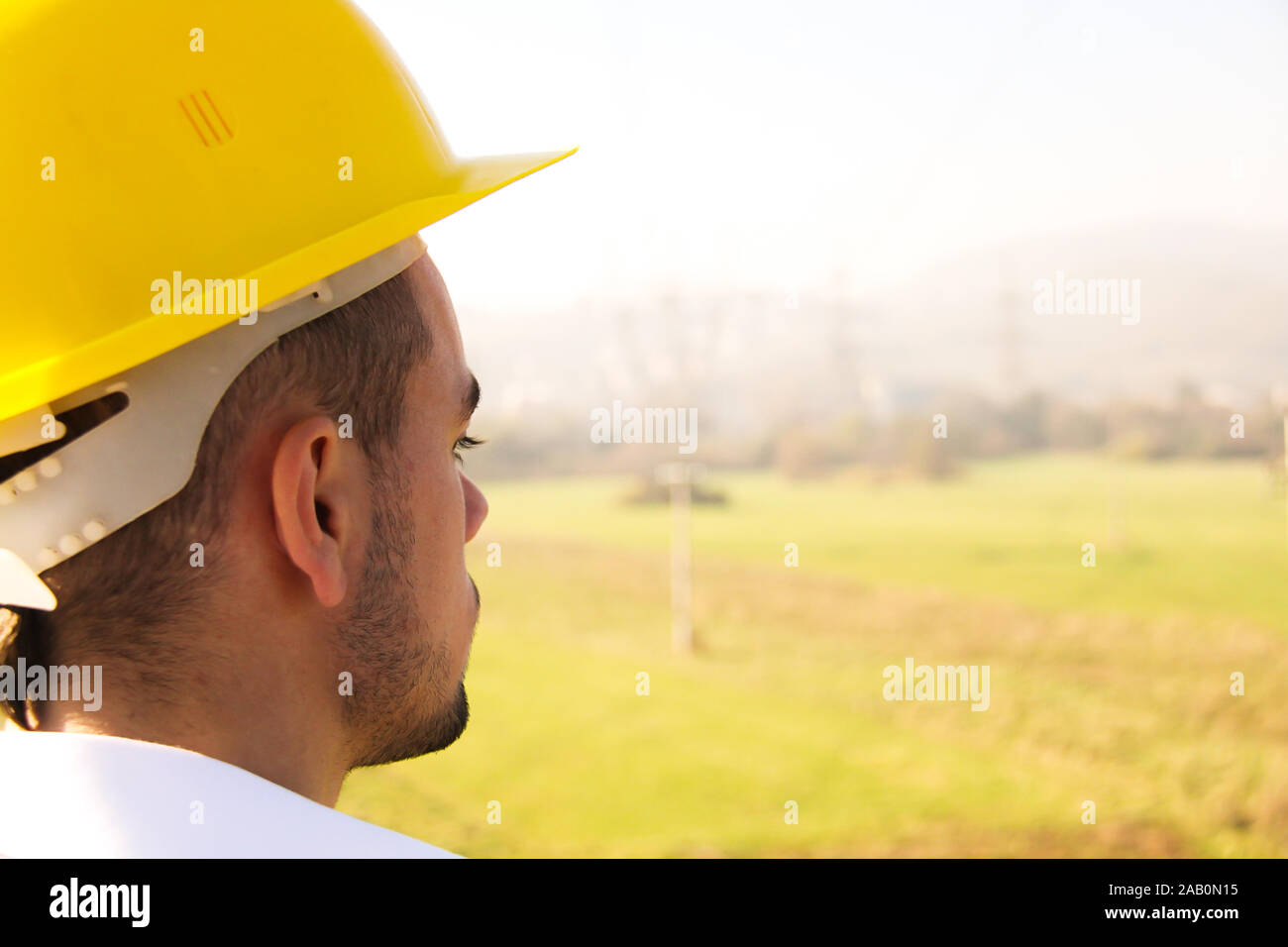 Male engineer standing at electricity station Stock Photo - Alamy