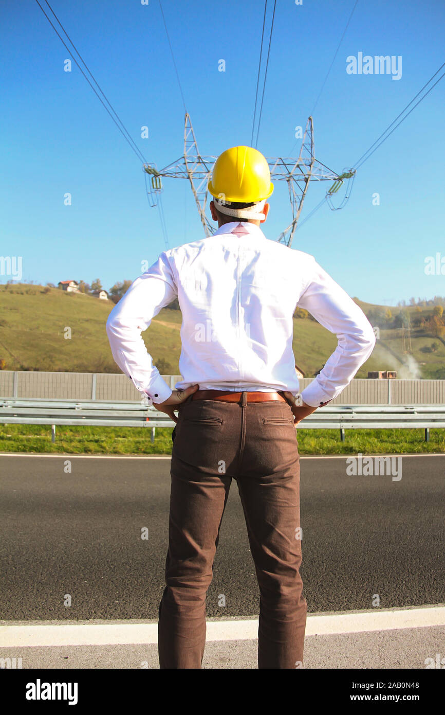 Male engineer standing at electricity station Stock Photo - Alamy