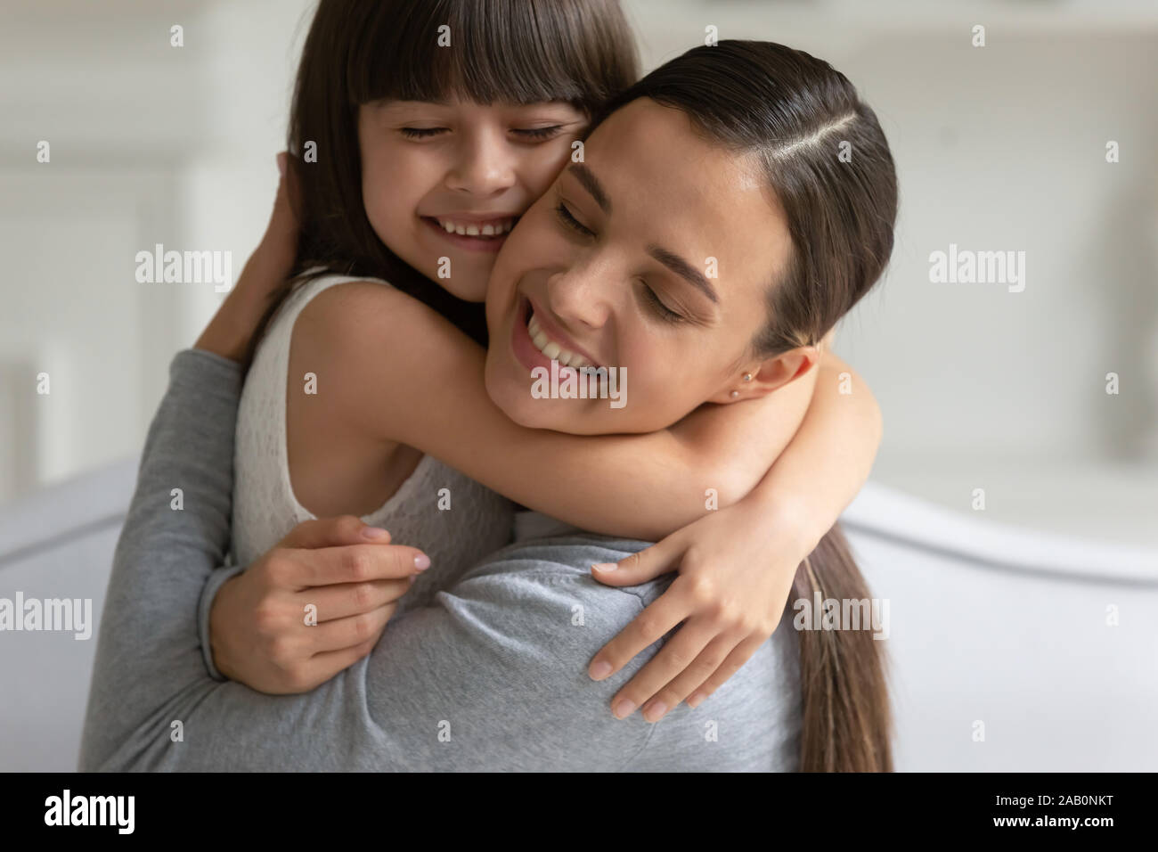 Mother cuddle daughter feeling love and connection closeup view Stock ...