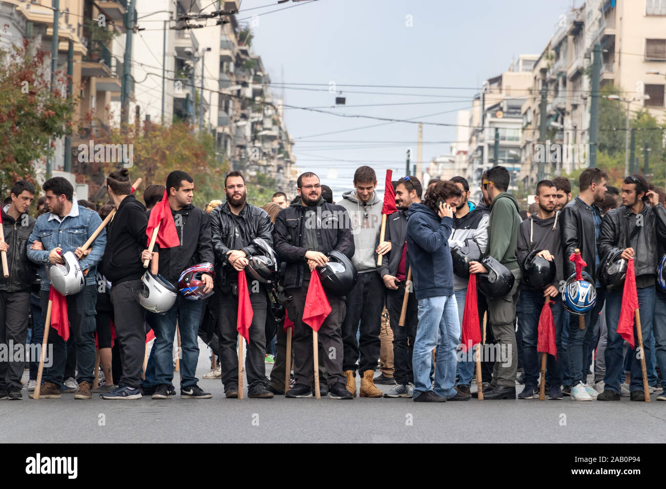 Communist party KKE supporters march holding their red flags through ...
