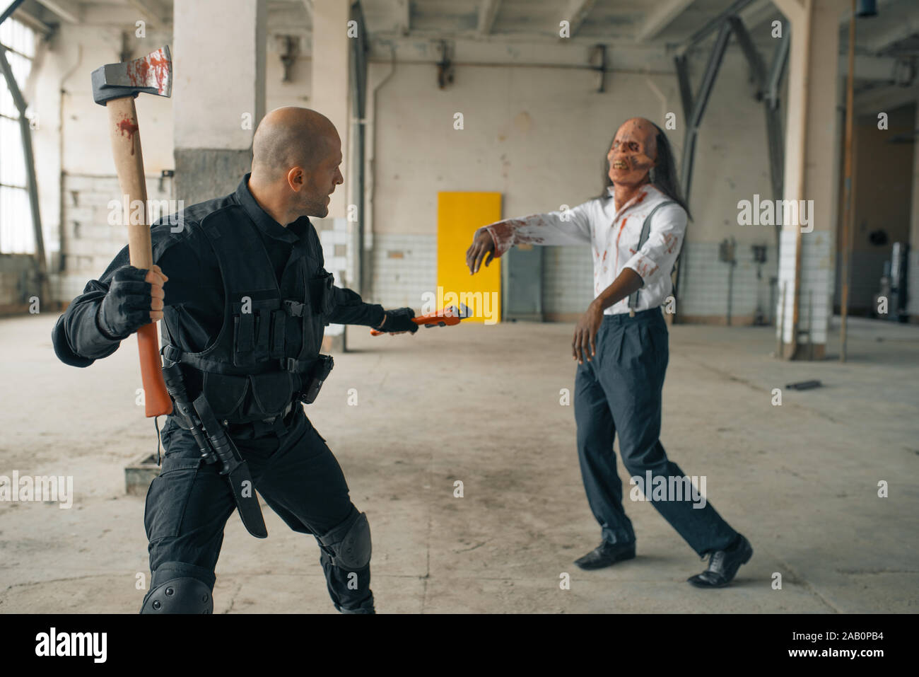 Military man with axe, zombie in abandoned factory Stock Photo - Alamy