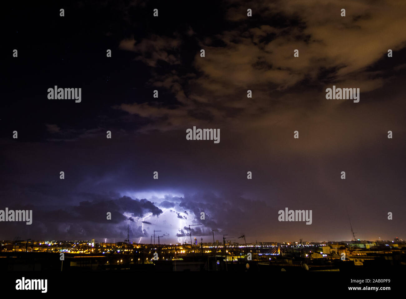 Thunderbolt strikes the city during a storm at night with clouds Stock ...