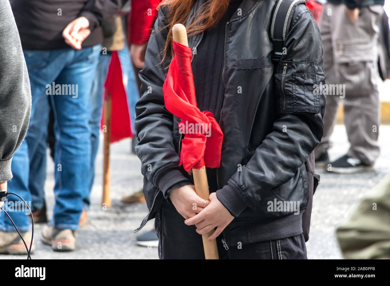 Communist party KKE female supporter holding her red flags standing ...