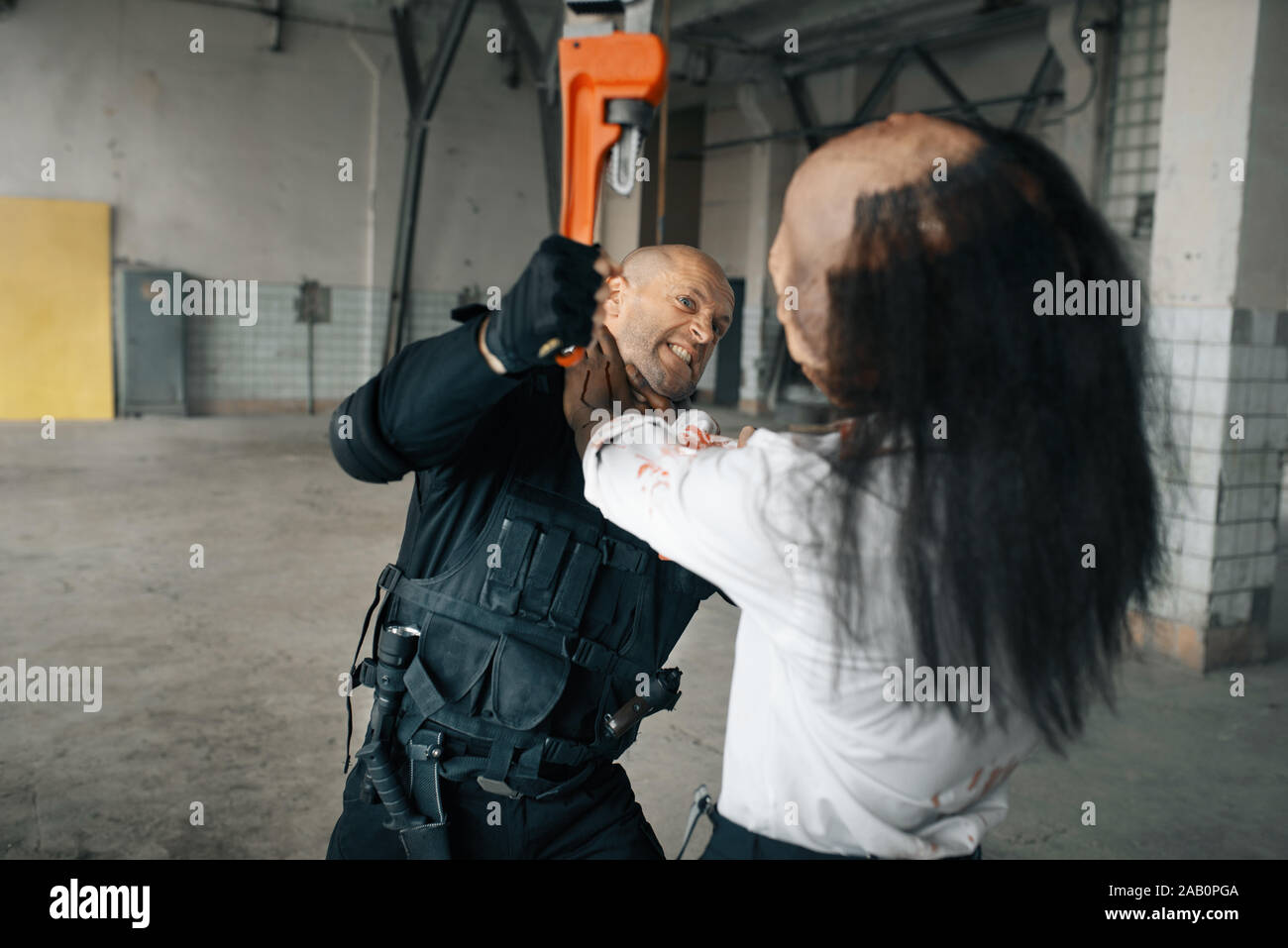 Man fights with cruel zombie in abandoned factory Stock Photo - Alamy