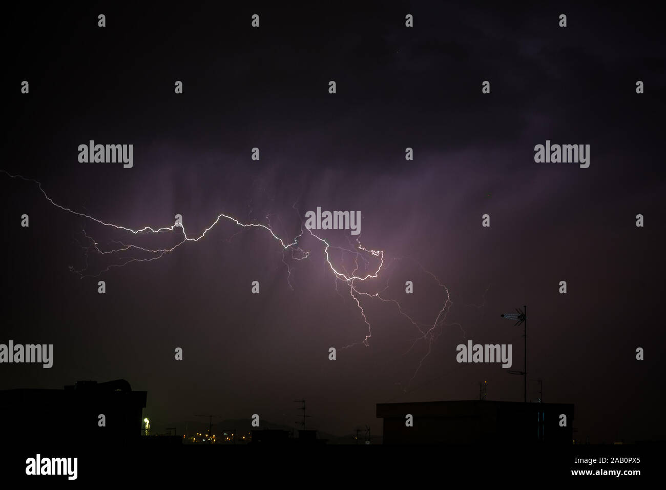 Thunderbolt over the city during a storm at night with clouds Stock ...