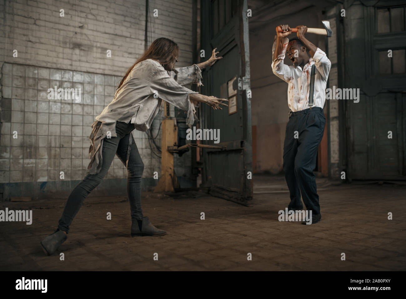 Female zombie fights with scaried man Stock Photo - Alamy