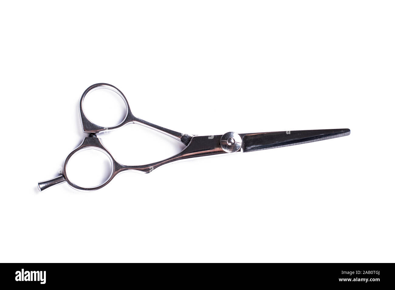 Silver hairdressing scissors on white background Stock Photo - Alamy