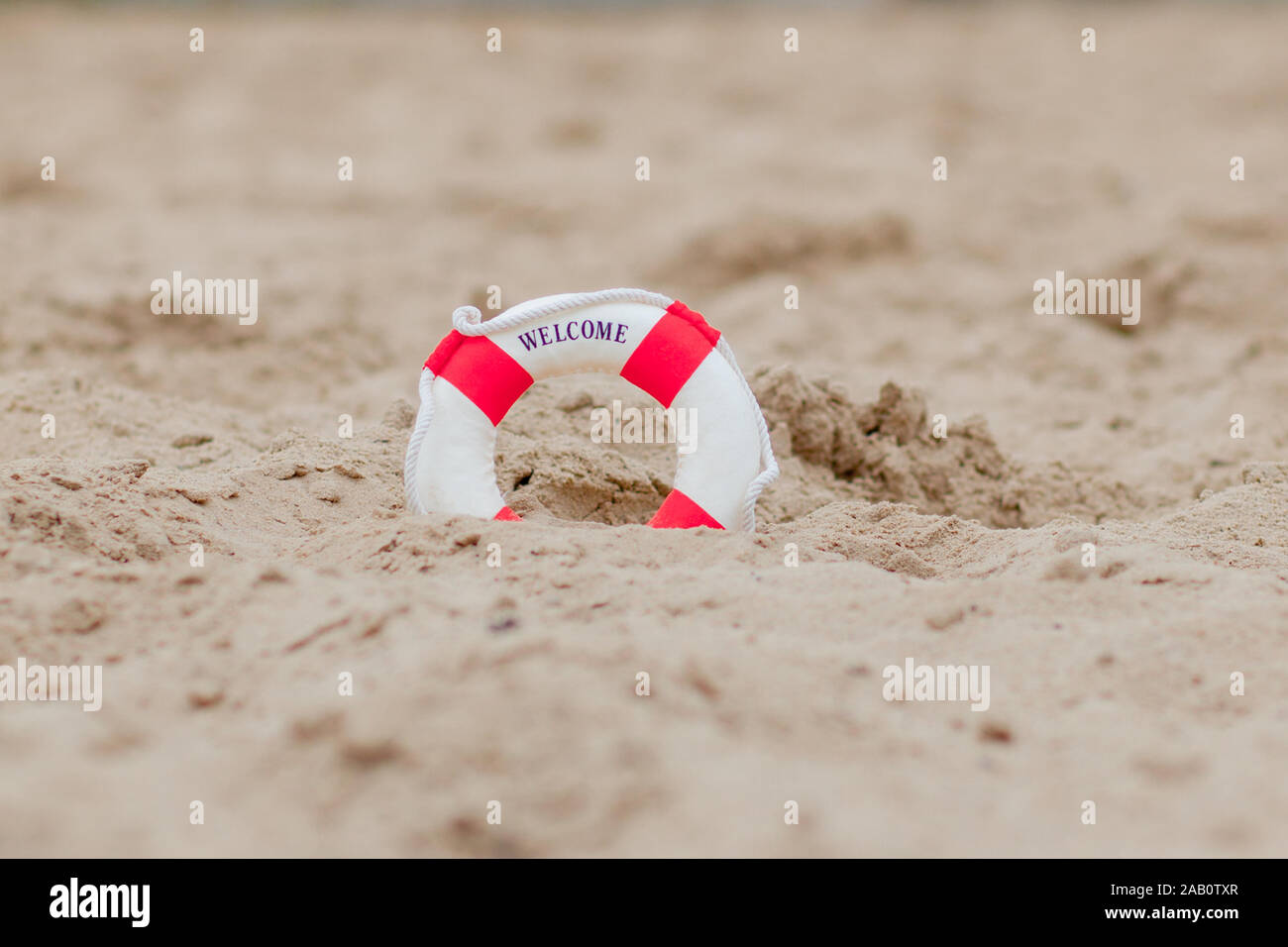 Close-up Of Miniature Lifebuoy Dig In The Sand At Beach Stock Photo - Alamy