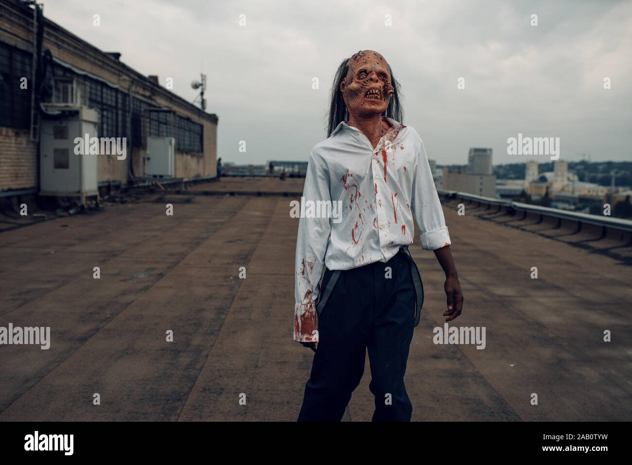 Scary zombie on the roof of abandoned building Stock Photo - Alamy