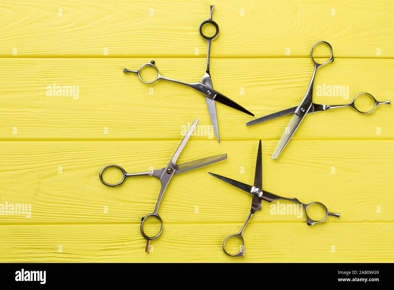 Professional barbers scissors on yellow background Stock Photo - Alamy