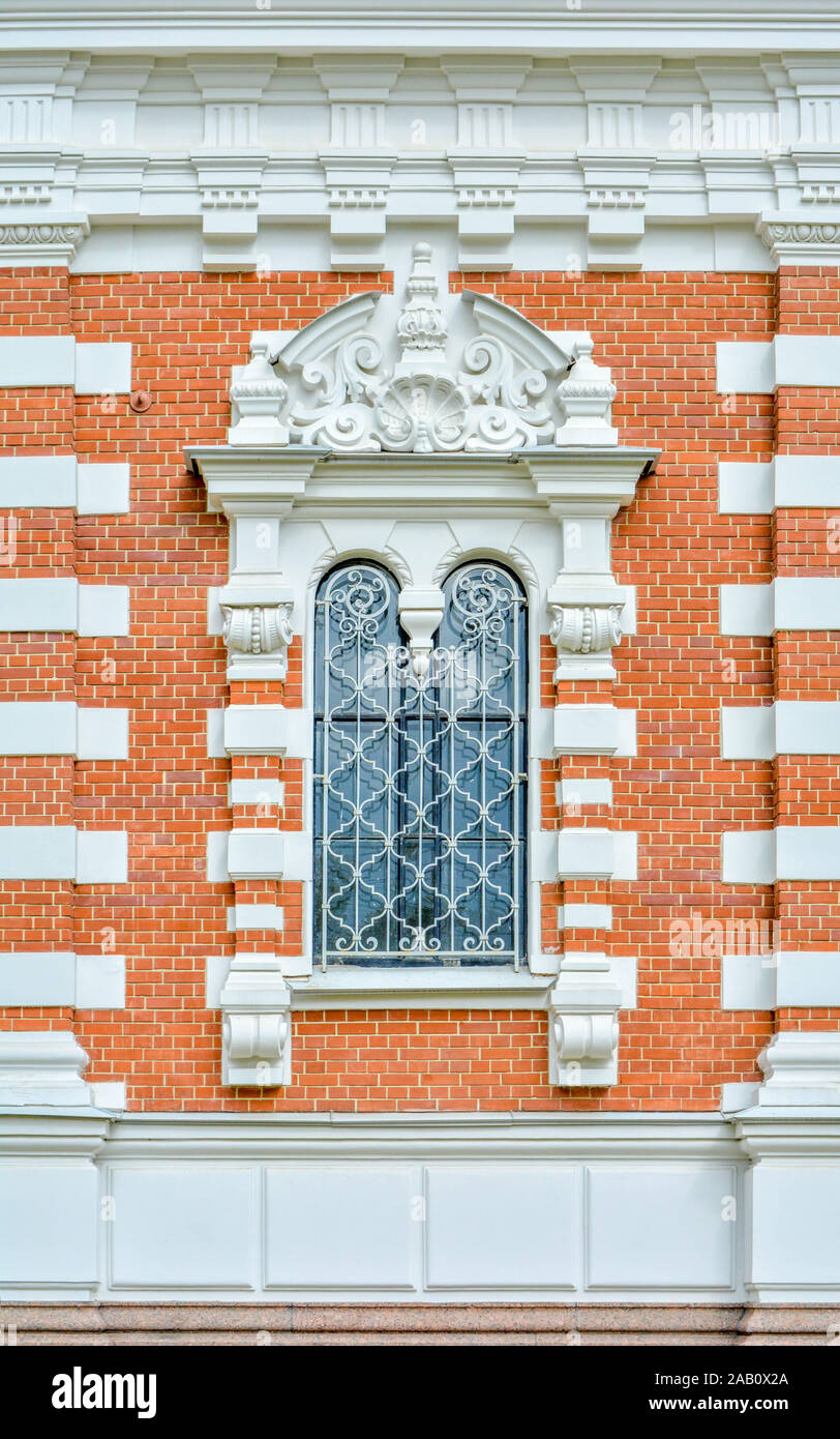 Close-up of ancient vintage arch window with cast iron white painted ...