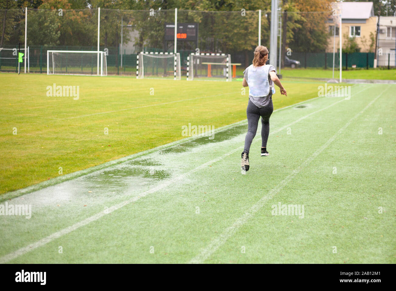Time Running Sports Competition. Runner on a treadmill. A woman ...