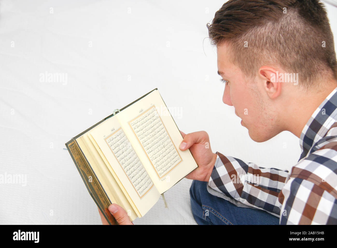 Photo of the Young man reading the Holy Koran Stock Photo - Alamy