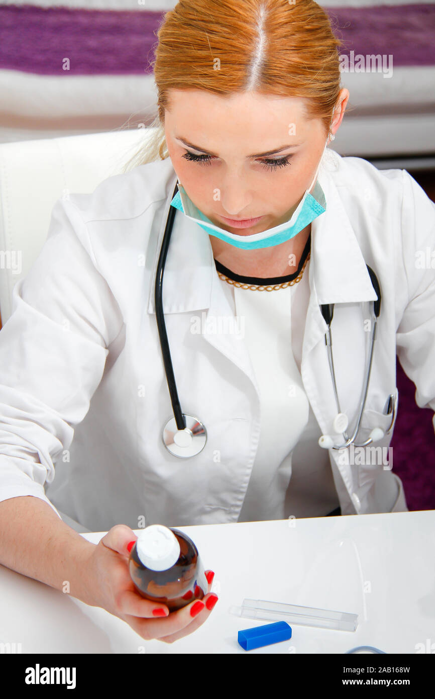Photo of the Young female doctor with mask and stethoscope Stock Photo ...
