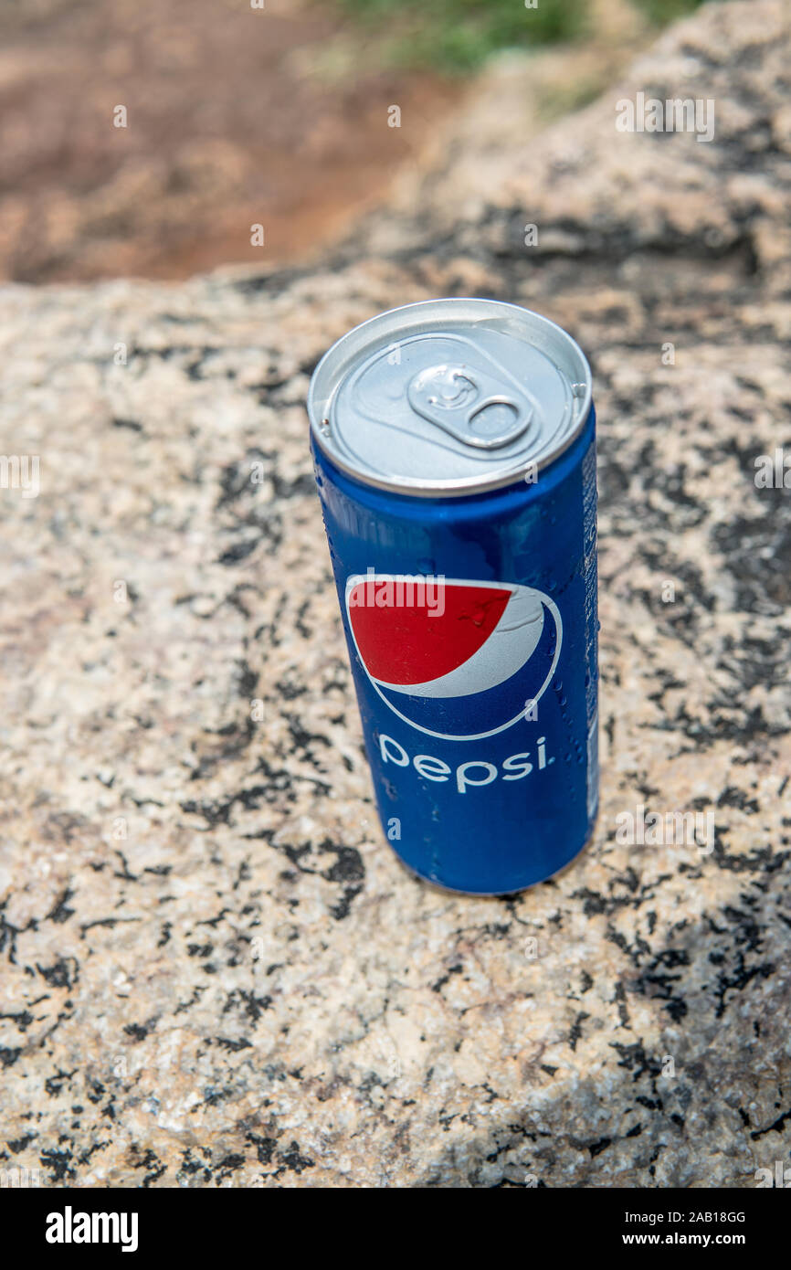 Bengaluru city, Lalbagh Botanical Garden Park, Pepsi Cola can on rocky ...