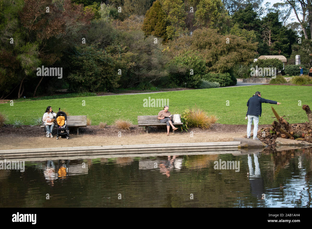 People gather around a pond at Golden Gate Park in San Francisco Stock ...
