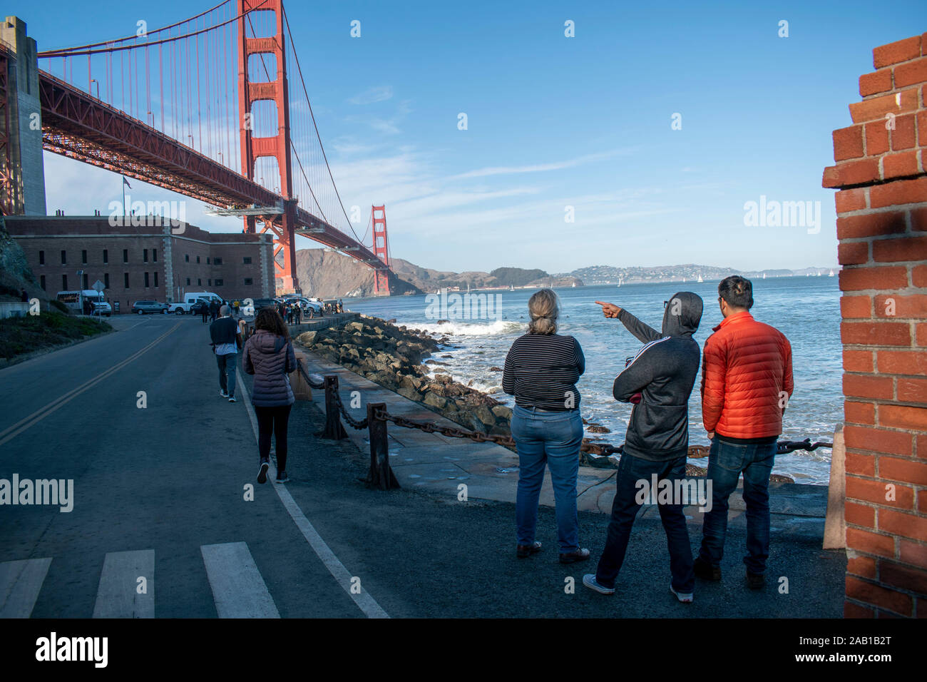 A group of people looks towards the Golden Gate Bridge in San Francisco ...