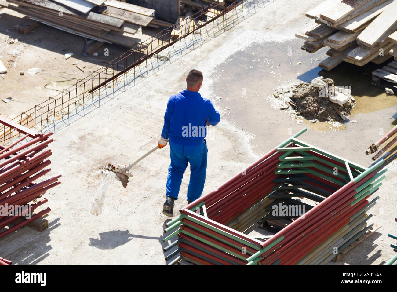 Photo of the Worker works with a shovel, cleaning rubble Stock Photo ...