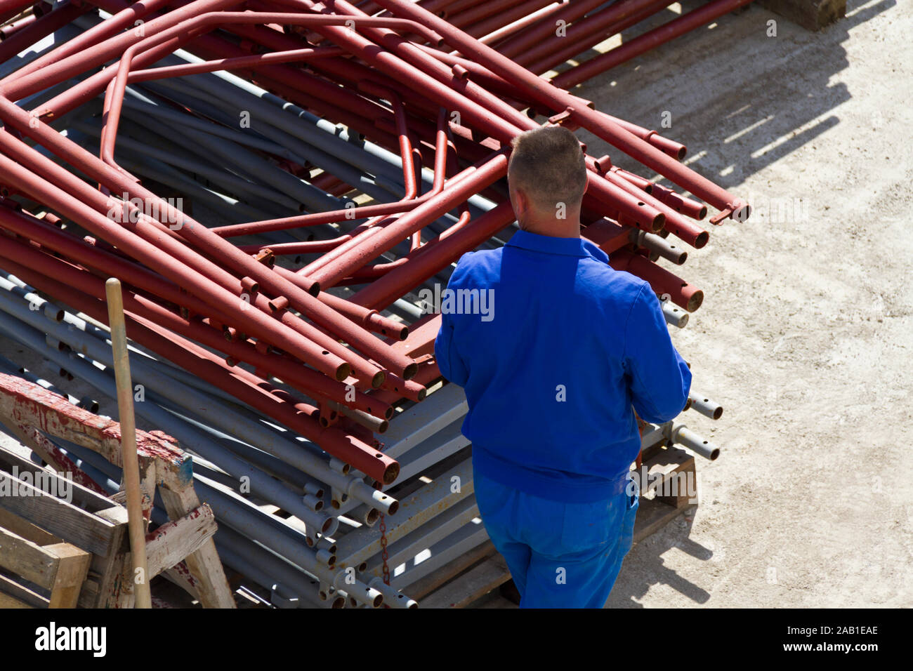 Photo of the Worker works with a shovel, cleaning rubble Stock Photo ...